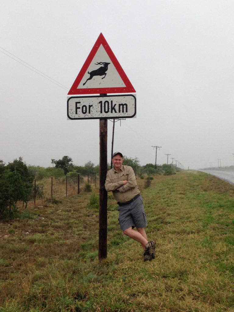 JD posing with Kudu Crossing Sign | JD African Safaris